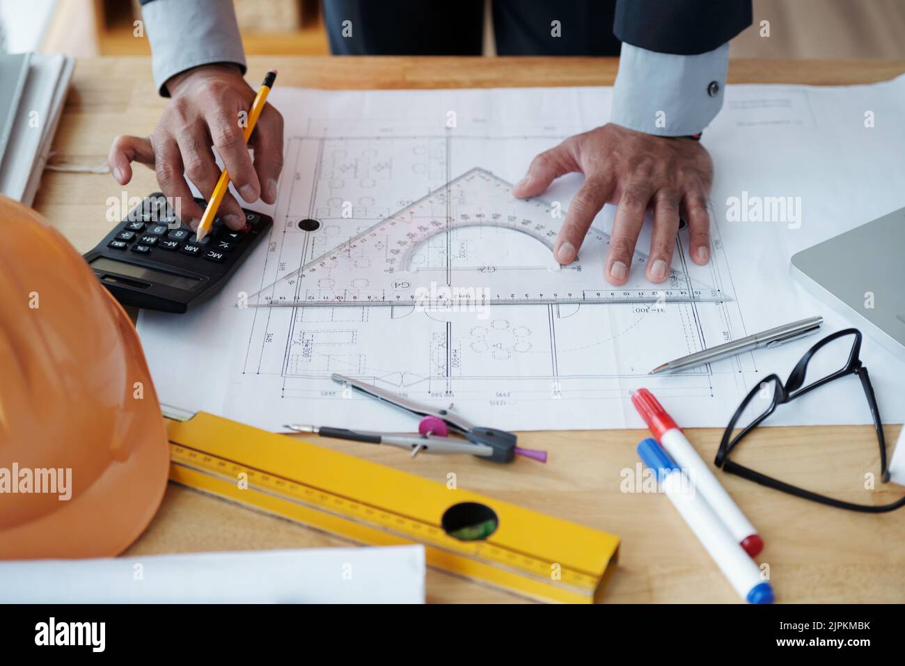 Hands of engineer checking construction plan on his table Stock Photo ...