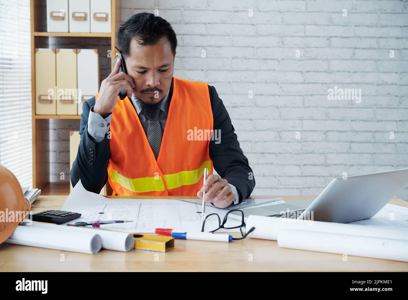 Project manager having phone call and taking notes Stock Photo - Alamy