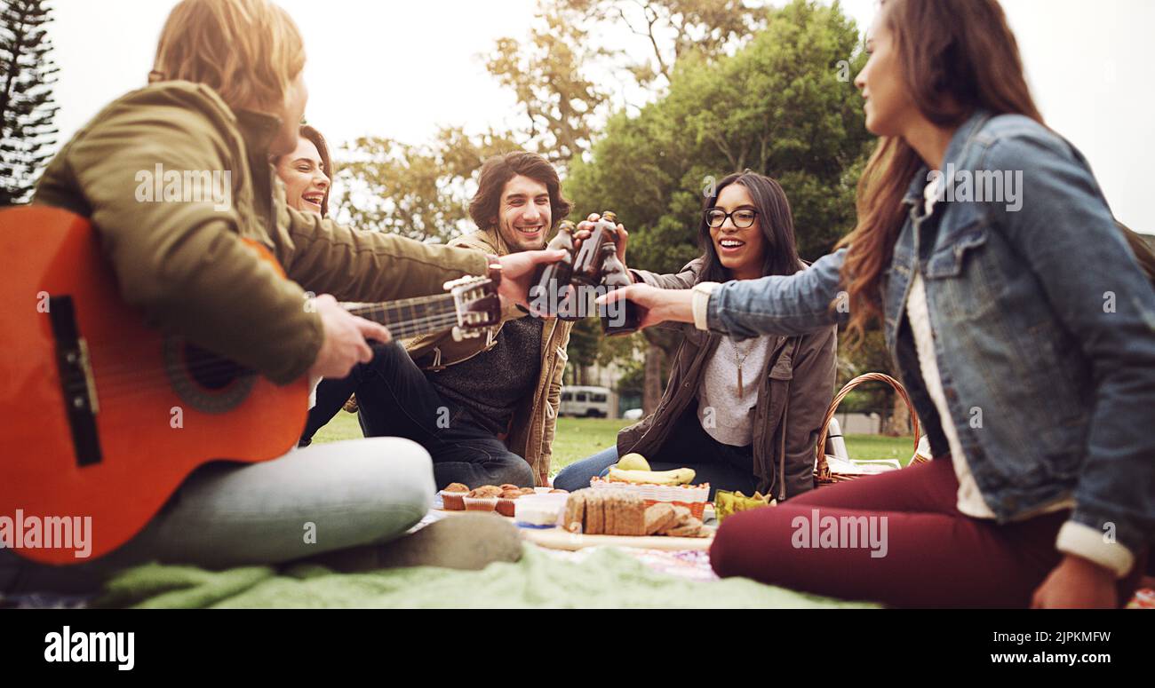 Fun with friends at the park. young friends having a picnic outside ...