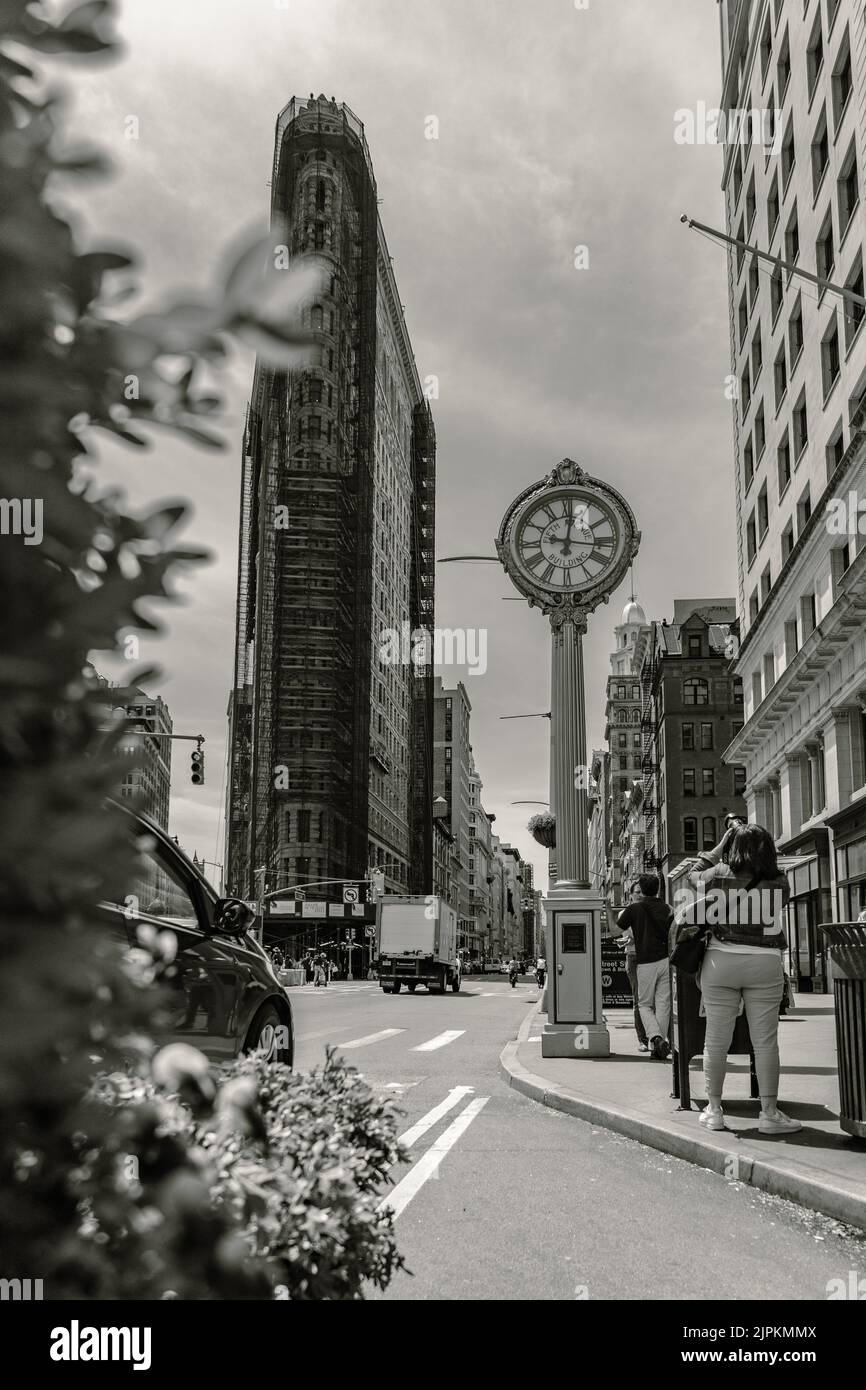 A grayscale vertical shot of the Flatiron Building in New York against ...