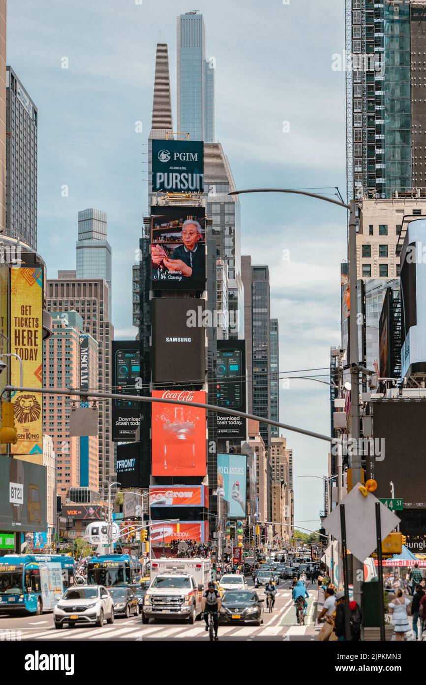 A vertical shot of a busy street at Times Square in New York during the ...