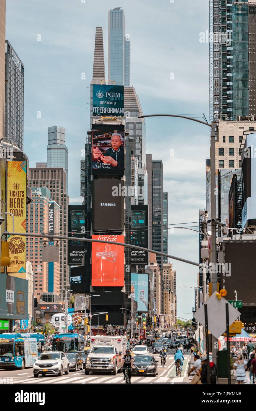 A vertical shot of a busy street at Times Square in New York during the ...
