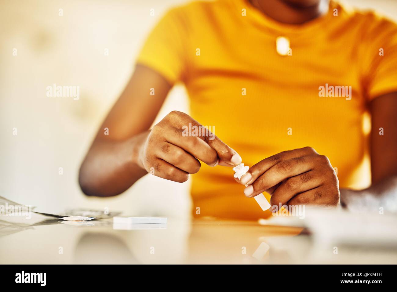 Hands of African female with HIV and Aids at home blood self test kit ...