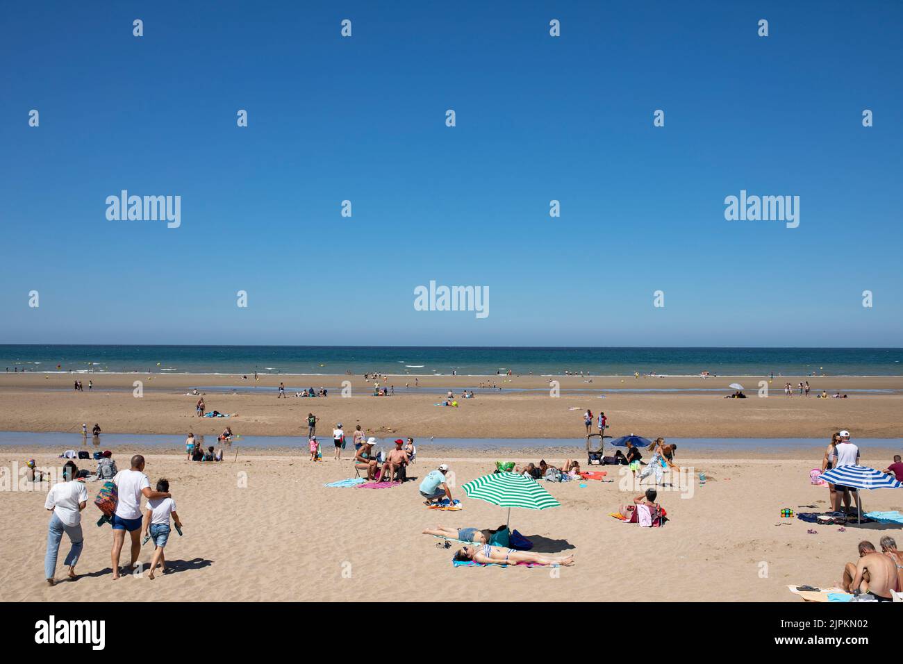 Sun tanning people at the beach of Benerville-sur-Mer, Normandy, France ...