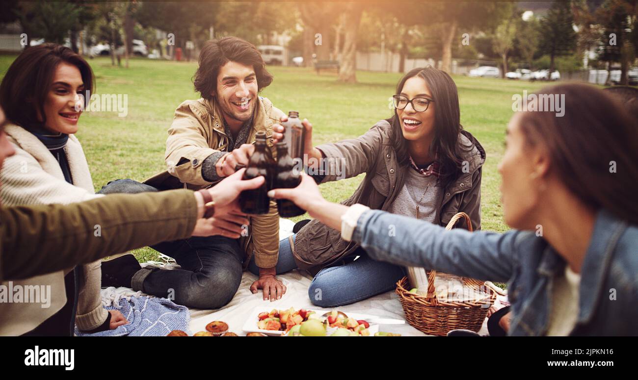 Fun with friends. young friends having a picnic outside Stock Photo - Alamy