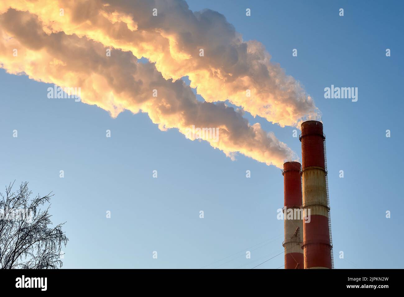 white smoke is coming out of the pipes in the blue sky Stock Photo - Alamy