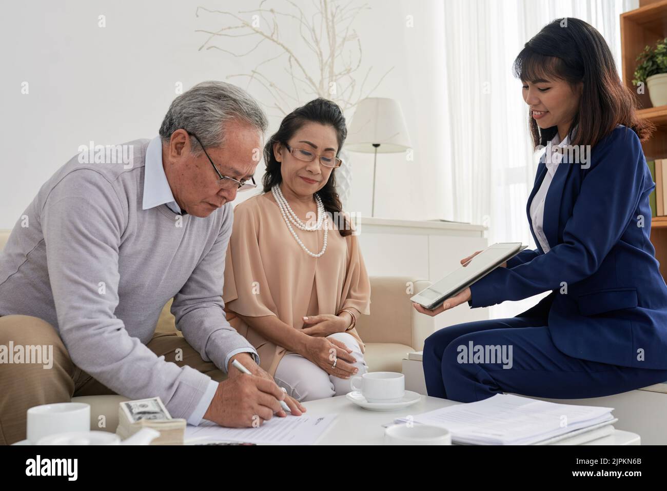 Asian man signing contract hi-res stock photography and images - Alamy