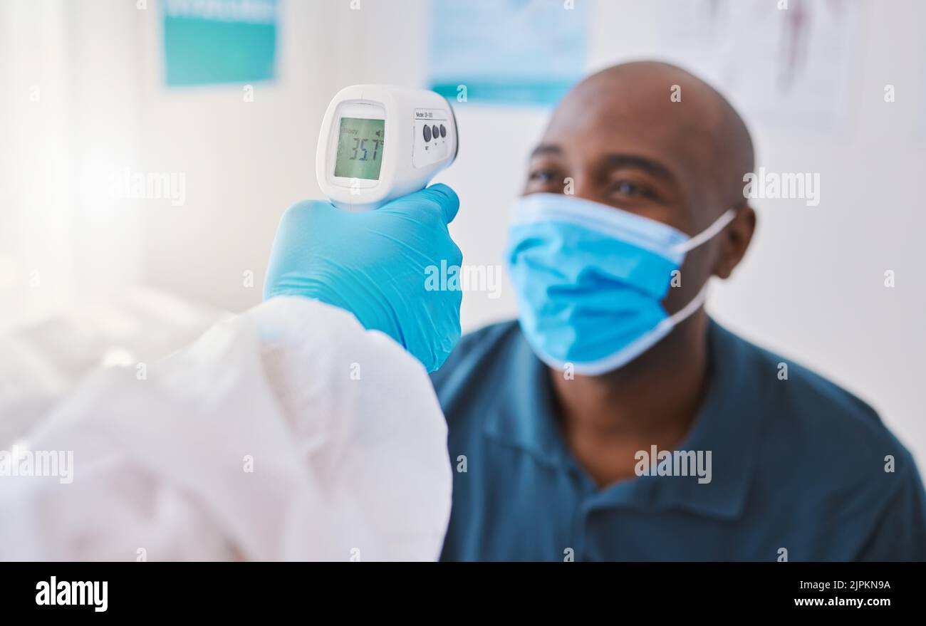 Checking for covid, corona or fever with a patient wearing a mask for ...