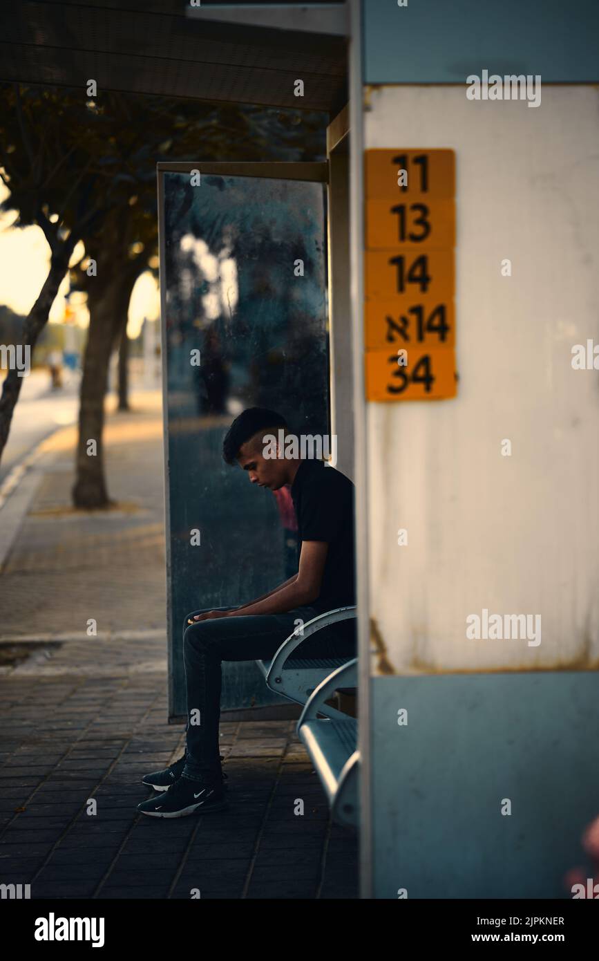 man waiting in a bus station Stock Photo - Alamy
