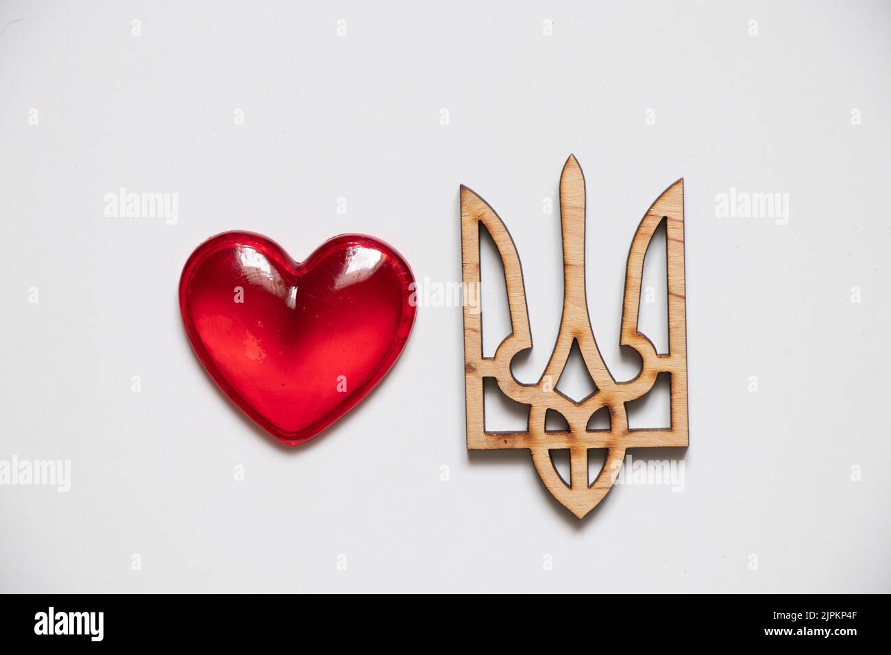 Coat of arms of Ukraine from a tree on a white background and a red ...