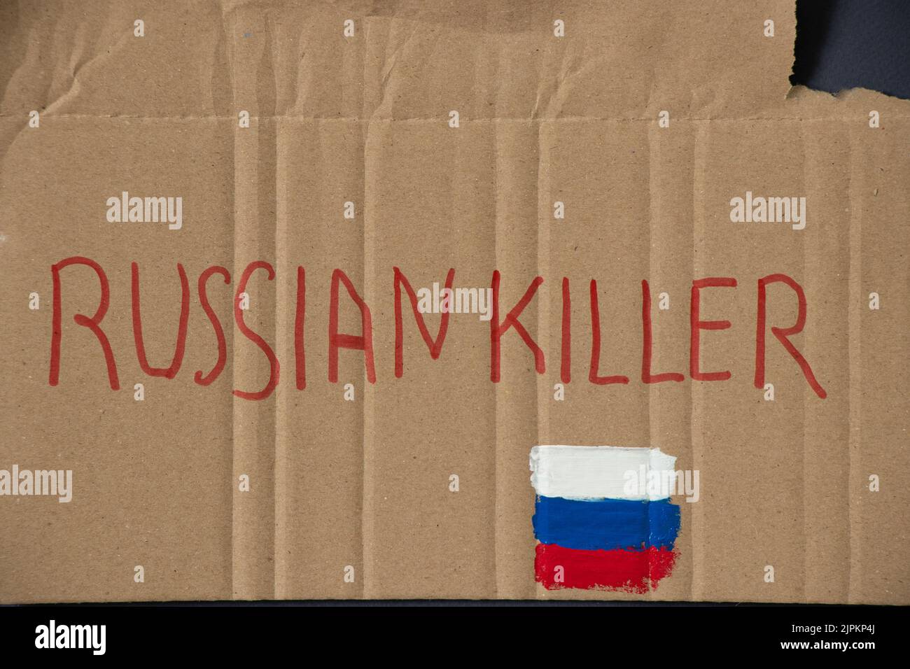 Russian killer is written on paper and the flag of Russia as a ...