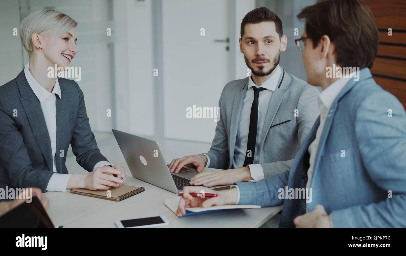 Businessman discussing future business project with male and female ...