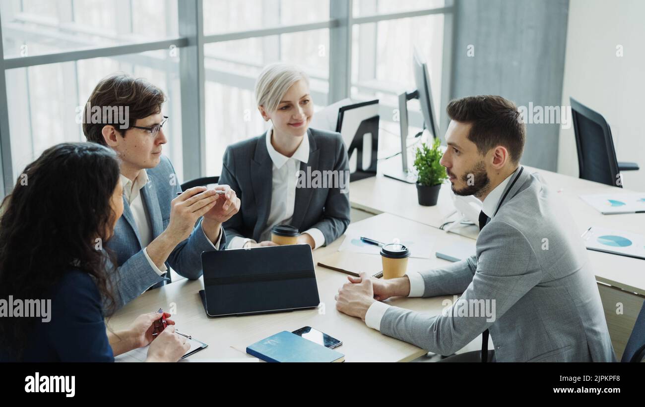 Businessman discussing future business project with male and female ...