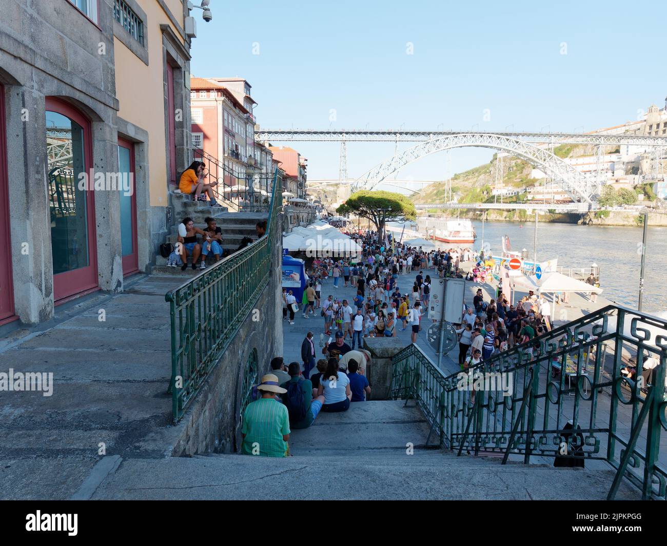 People relaxing on the steps in the Ribeira aka riverside district of ...