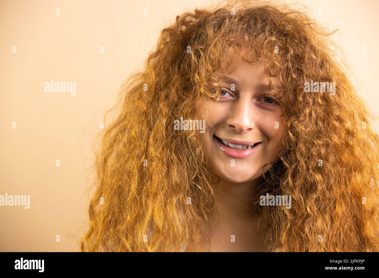 Picture of a funny joyful redhead pretty smiling woman looking at the ...