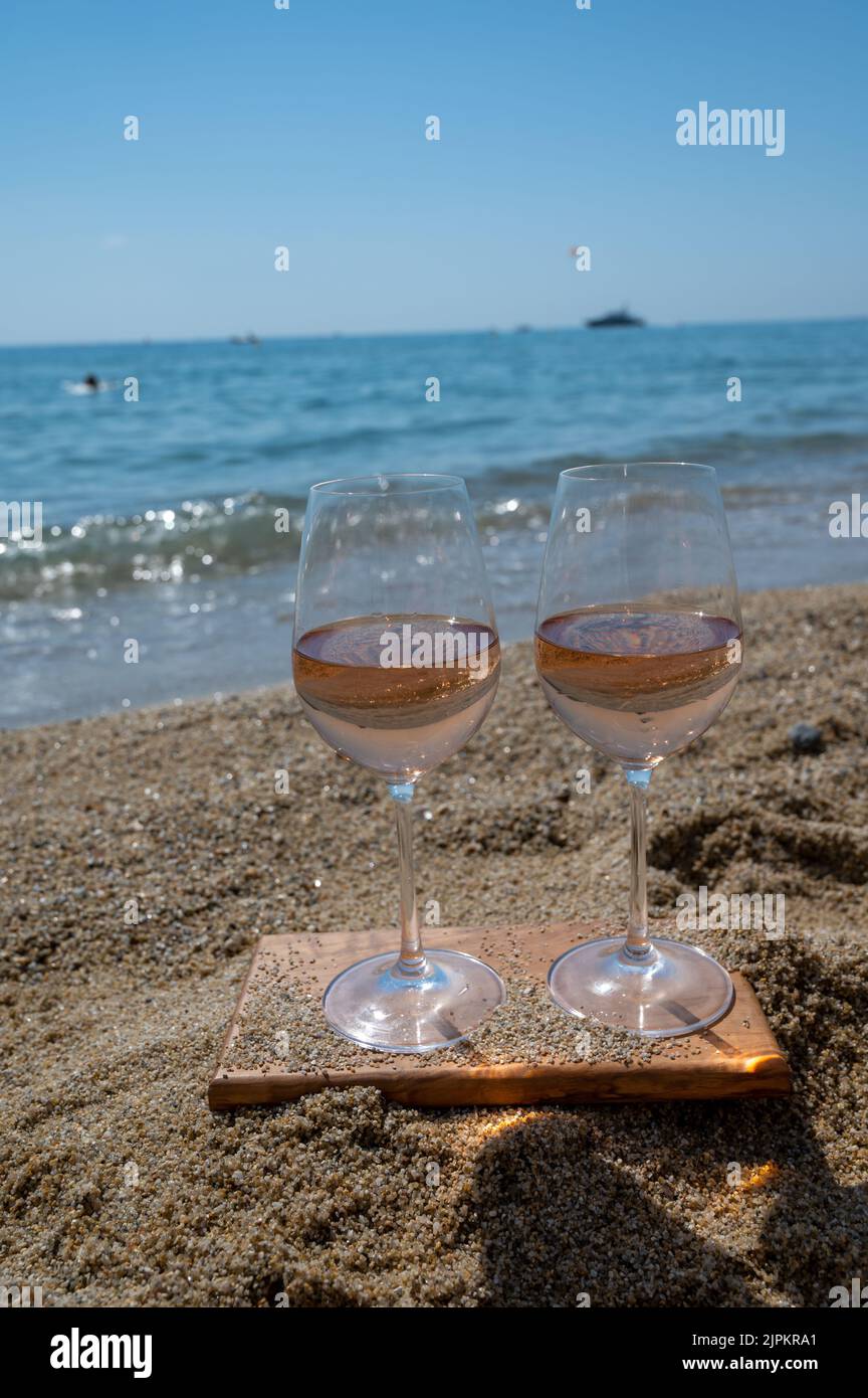 Cold rose wine from Provence served outdoor on white sandy beach Plage ...