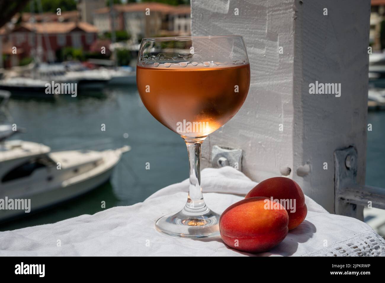 Drinking of cold rose wine from Provence with red apricots and view on ...