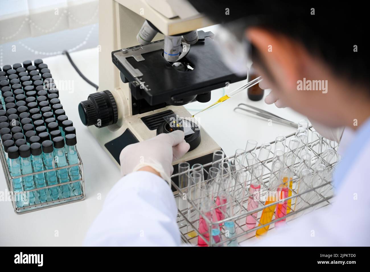 close-up image, Young Asian male scientist or chemist examining a virus ...