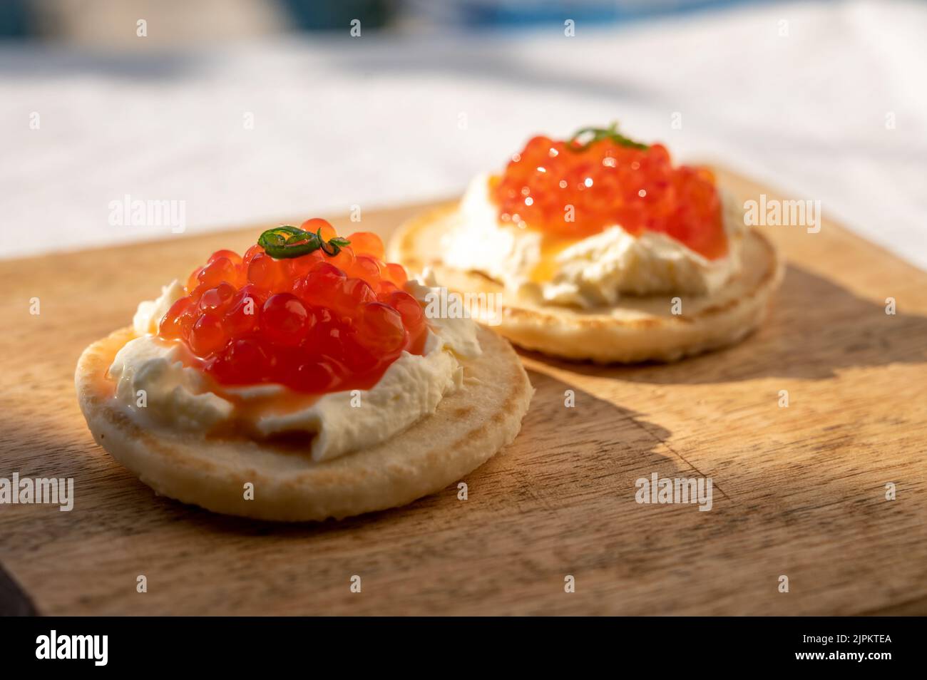 Two small starters blinis with sour cream and salted salmon red caviar ...