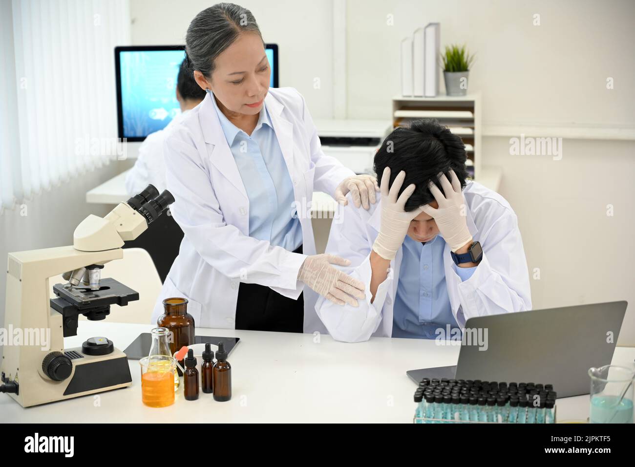 Serious millennial Asian male scientist or chemist upset and worried on ...