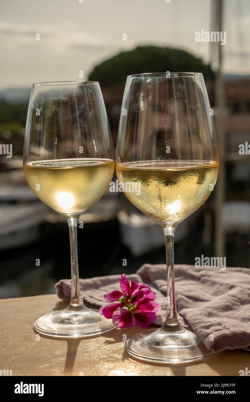 Drinking of cold white wine with view on yacht harbour of Port Grimaud ...