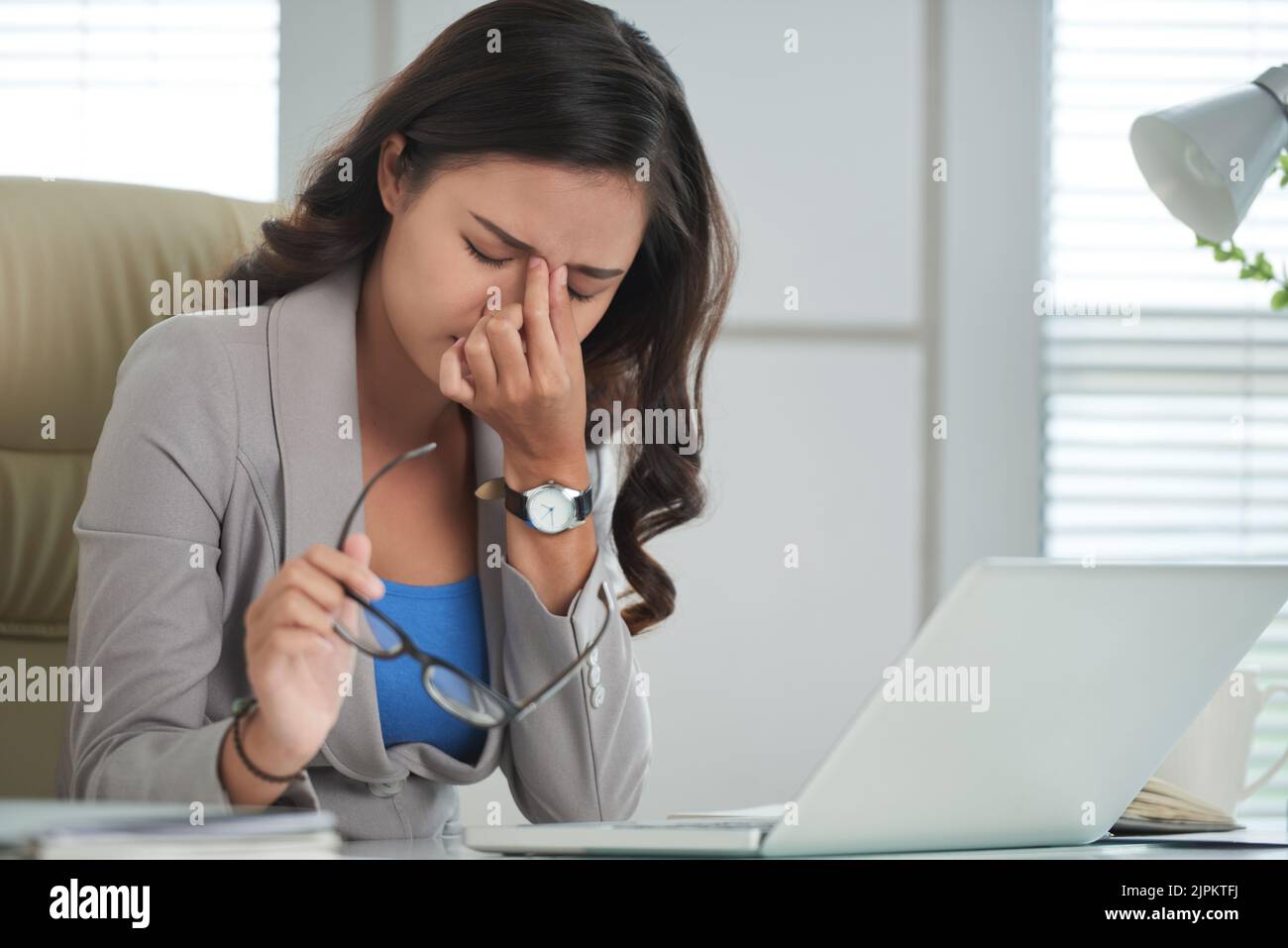 Portrait of stressed tired young Asian business lady Stock Photo - Alamy