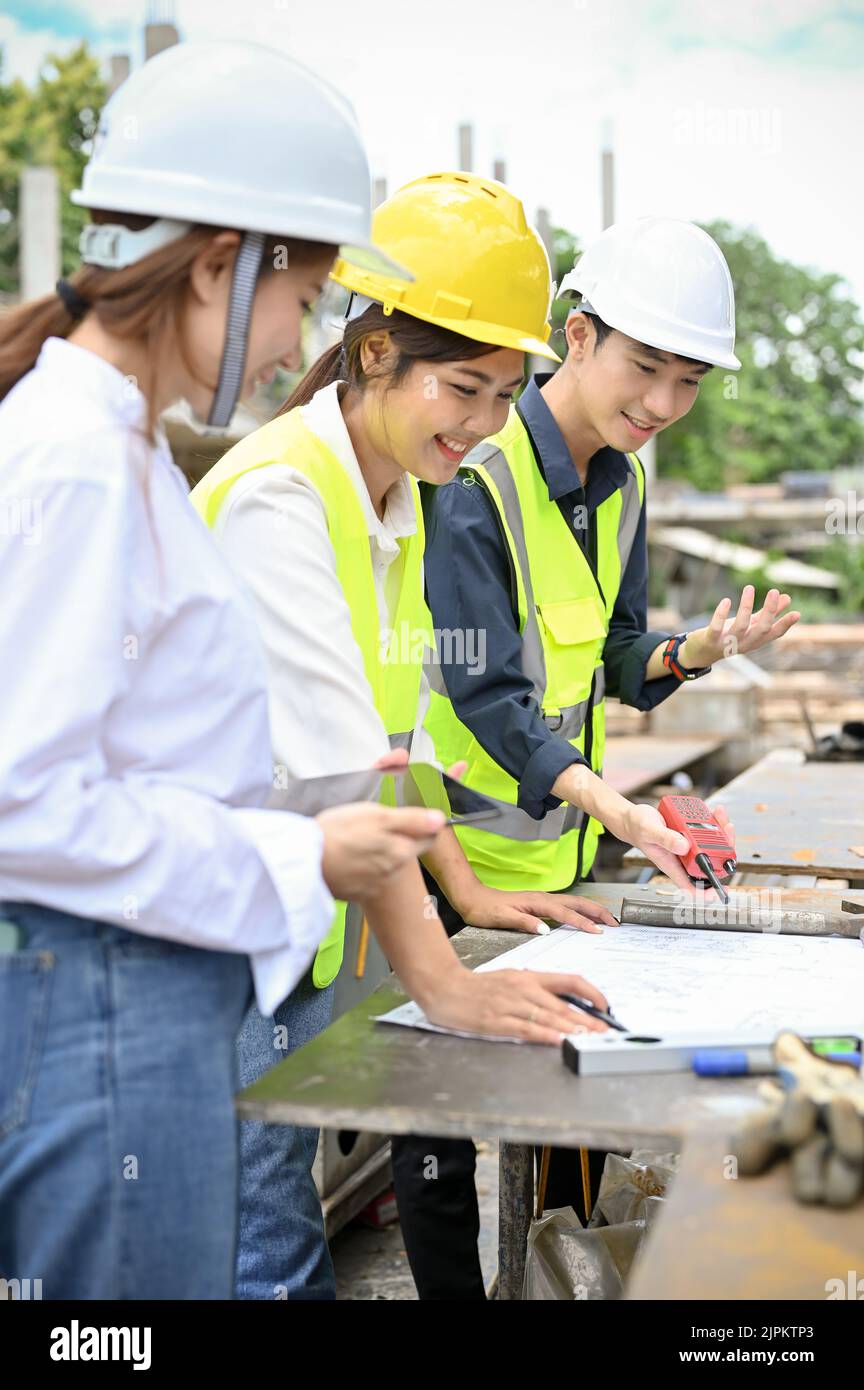 Team of a cheerful and professional millennial Asian civil engineer ...