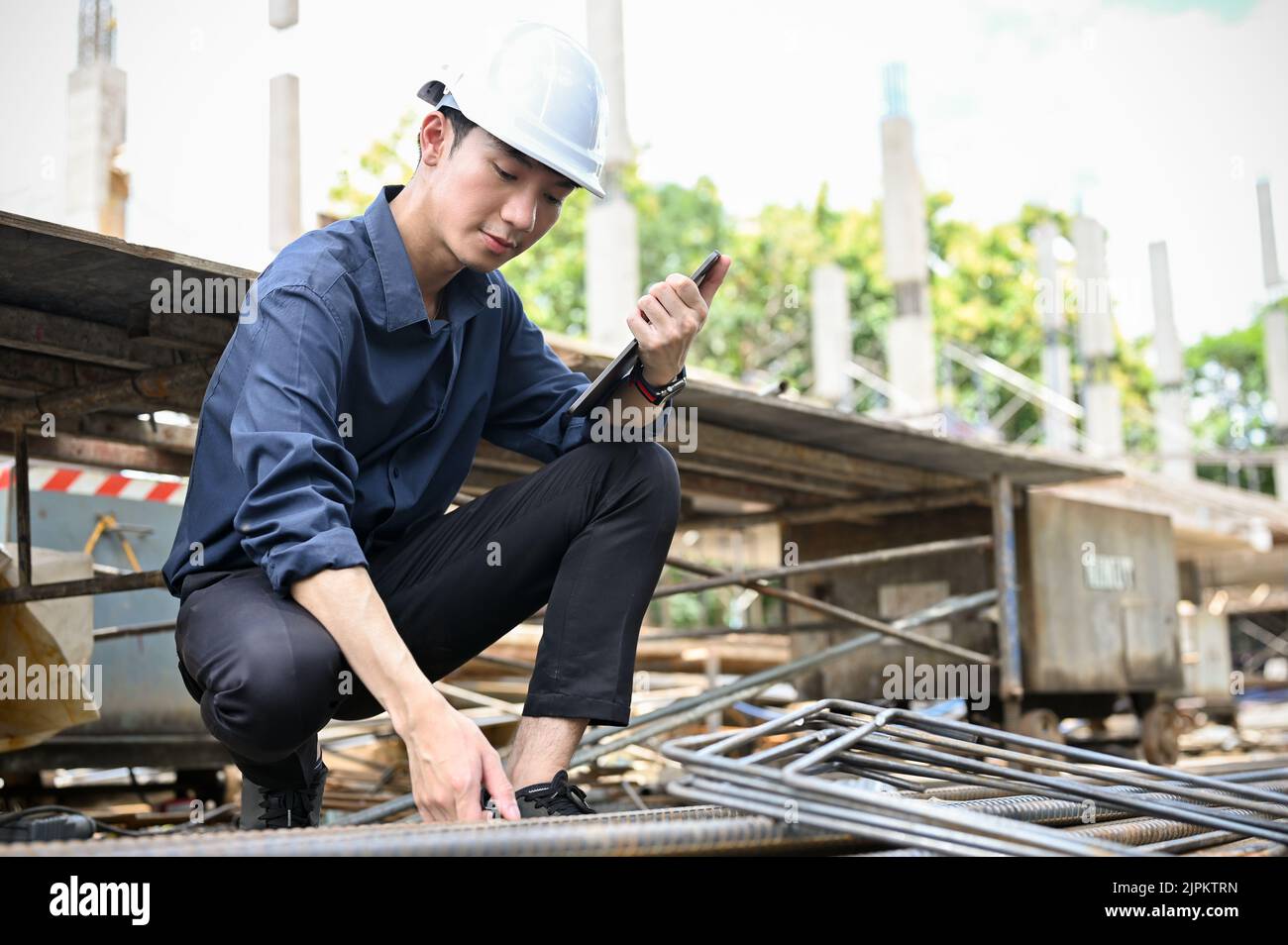 Handsome and professional young Asian male civil engineer in white ...