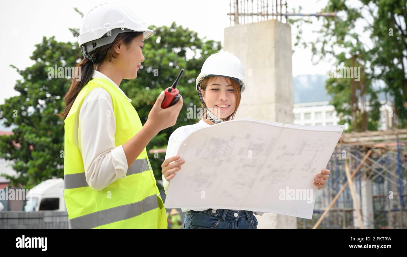 Two talented young Asian female civil engineer or architect discussing ...