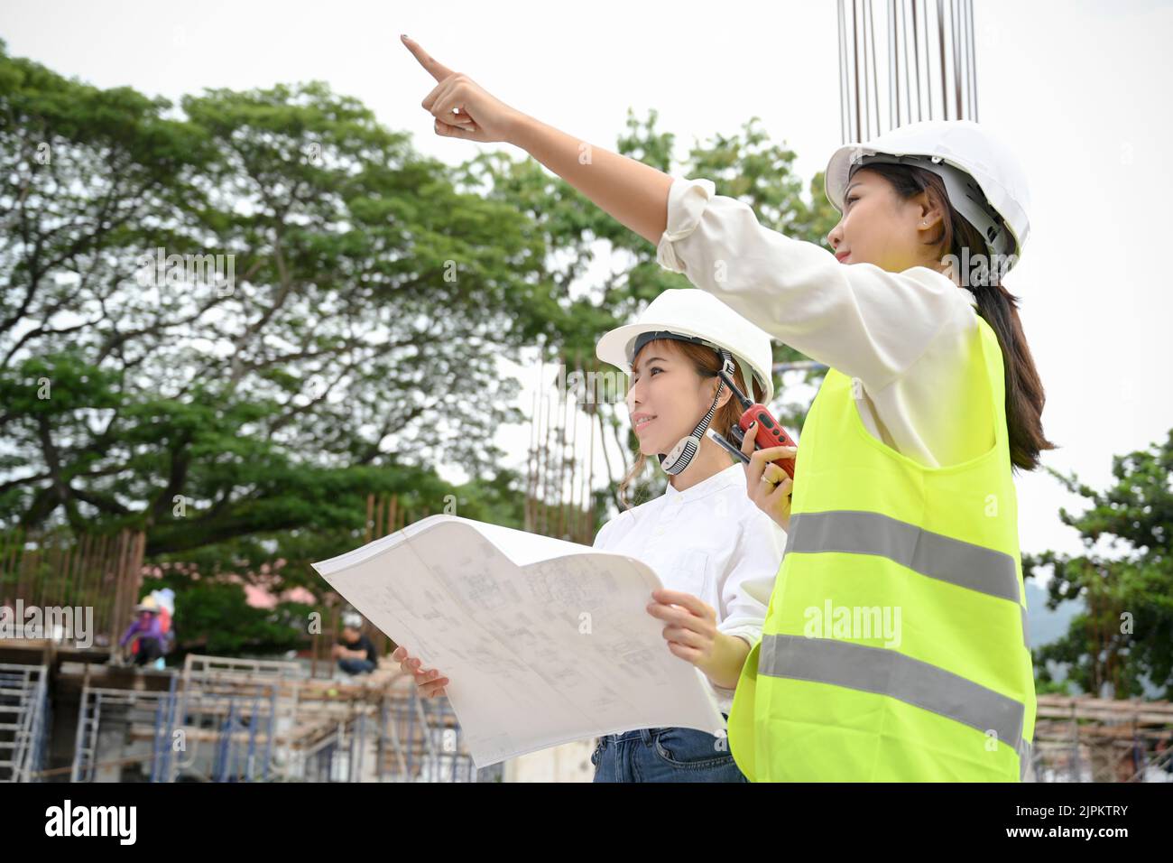 A professional millennial Asian female civil engineer explains a ...