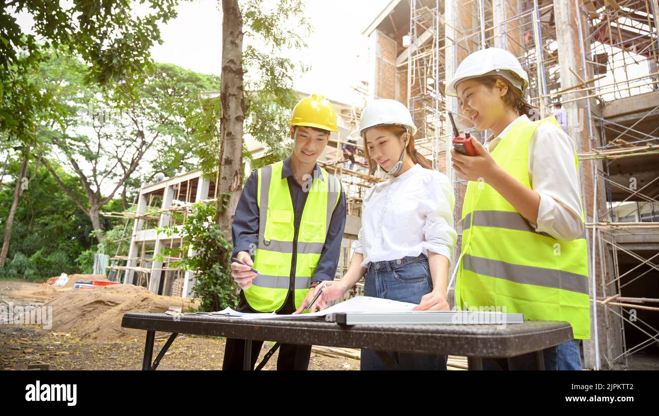 A team of talented young Asian females architects collaborating work ...