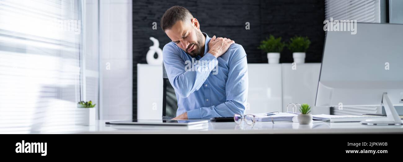 Posture Fatigue Shoulder Pain. Mature Man At Computer Workstation Stock ...