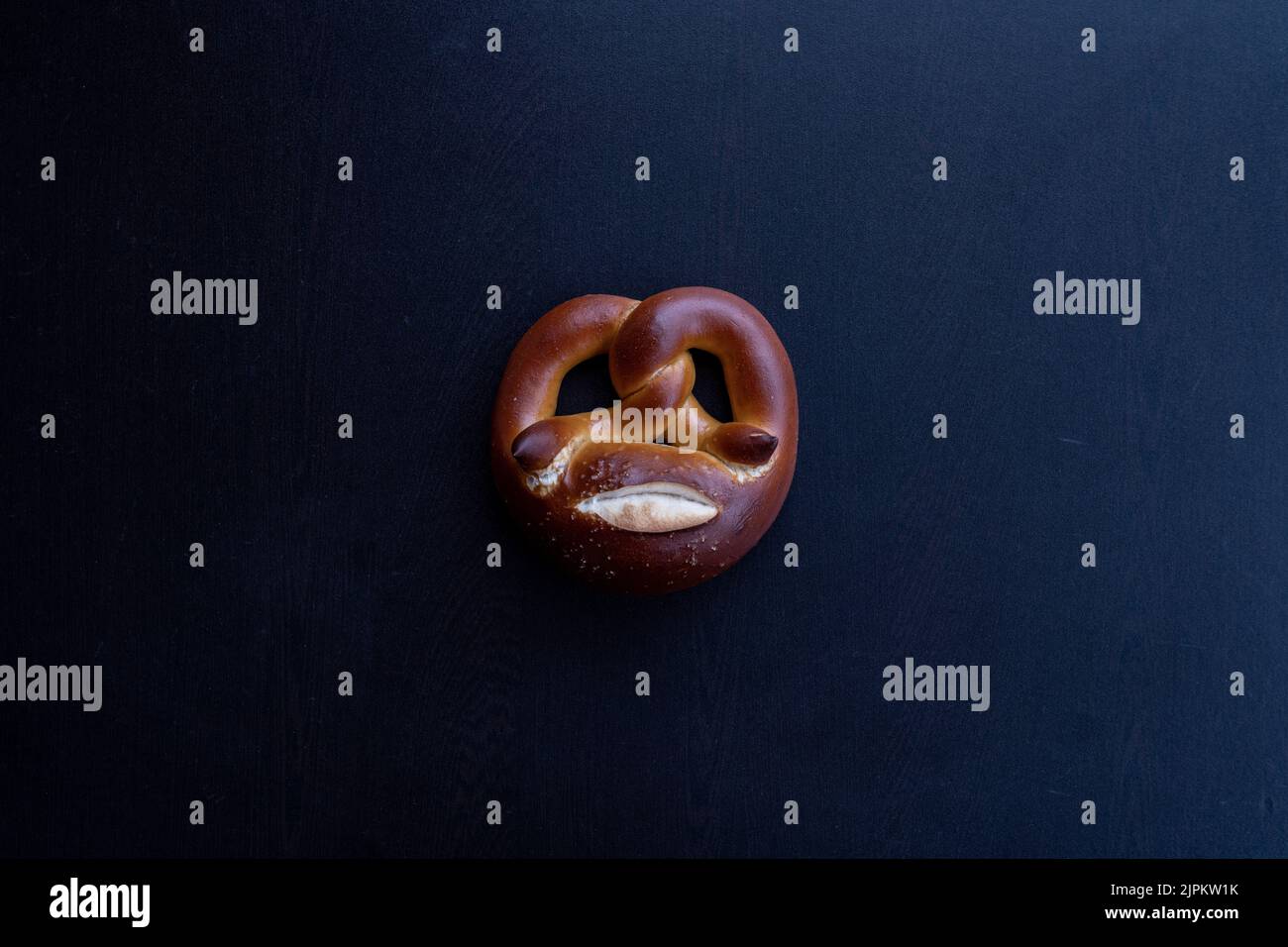 A top view of a pretzel on the dark background Stock Photo - Alamy