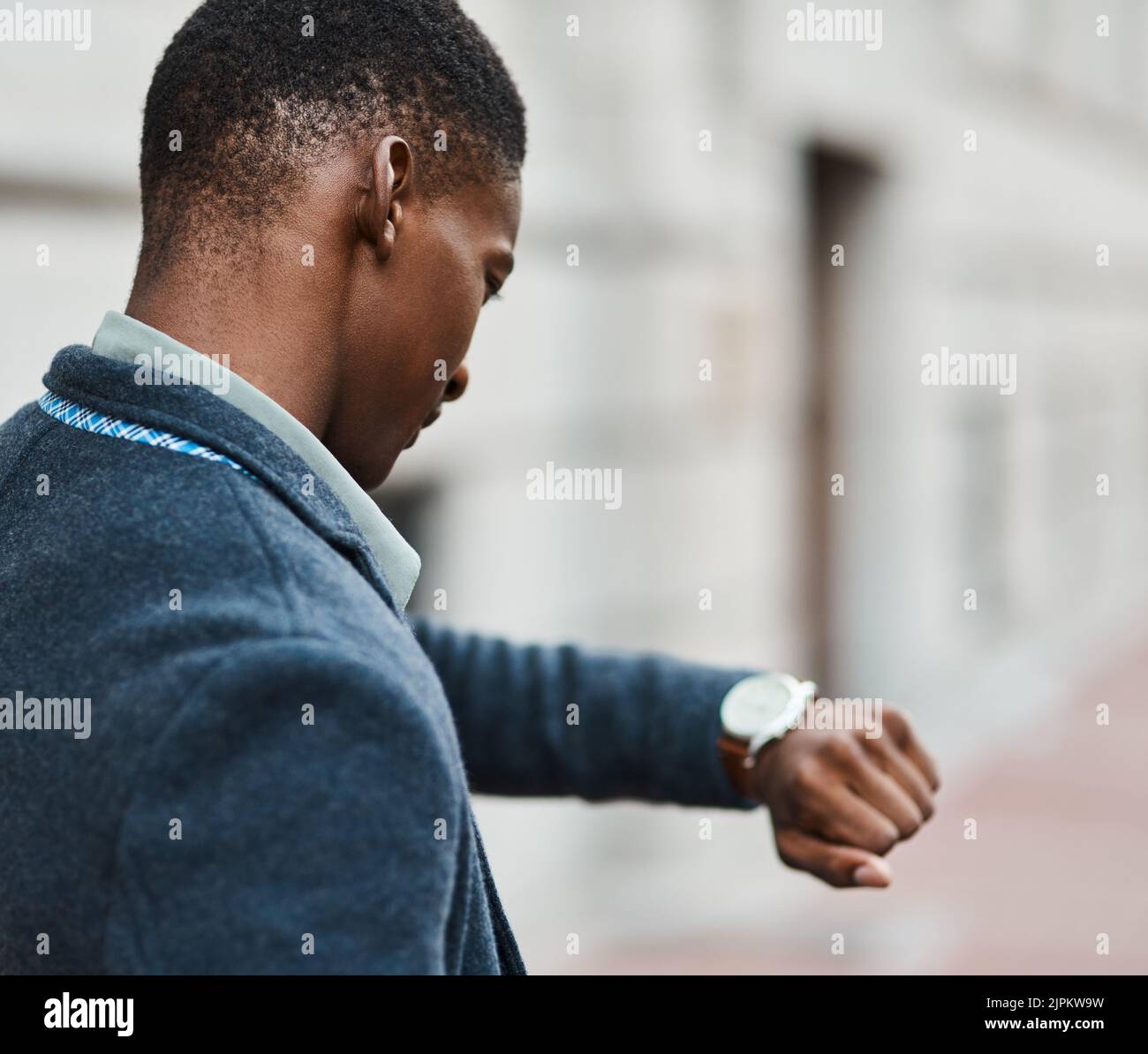 Running late, checking time on watch and feeling stressed, anxious and ...