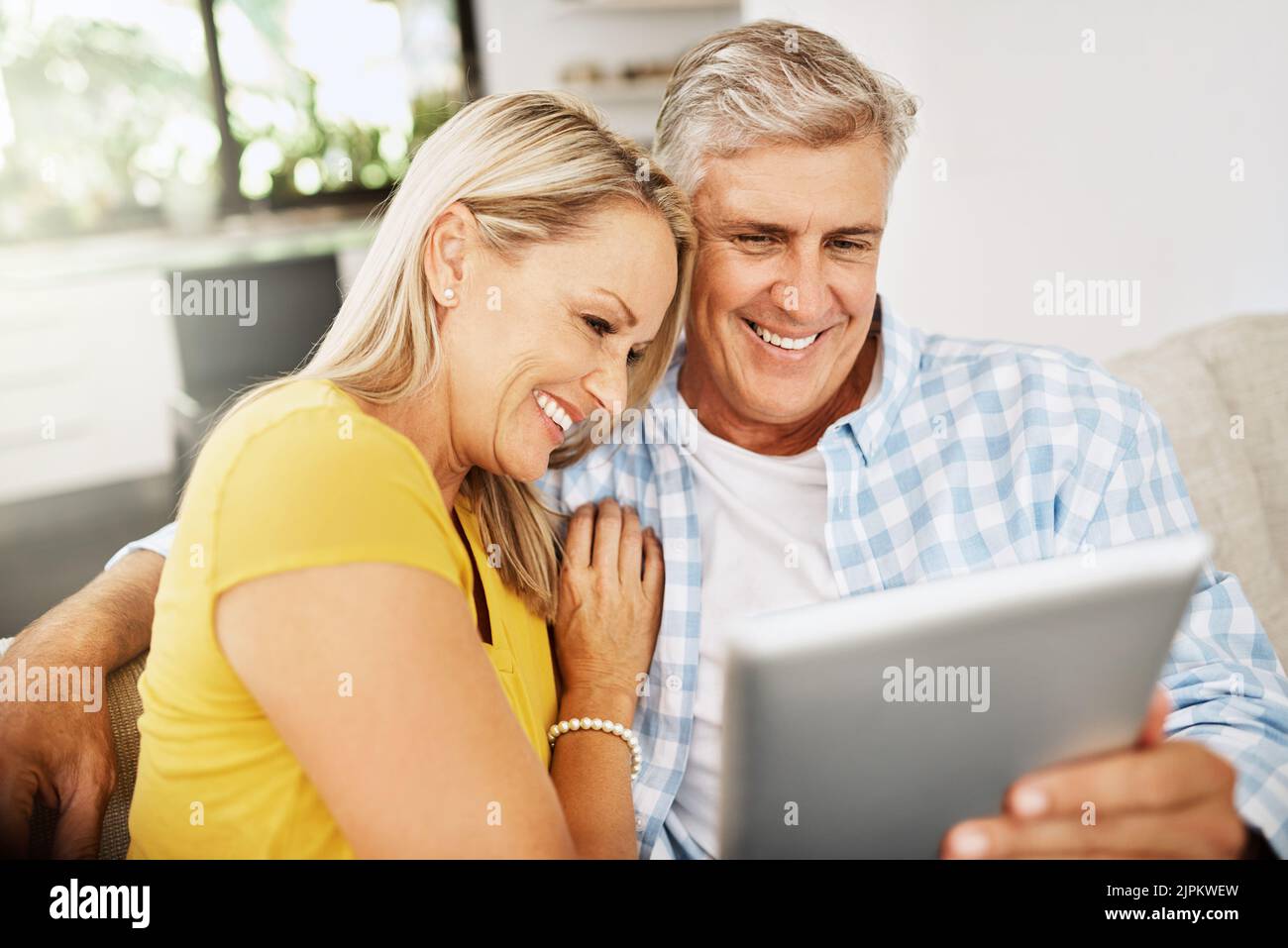 Happy, relaxed and in love mature couple watching a movie together on a ...