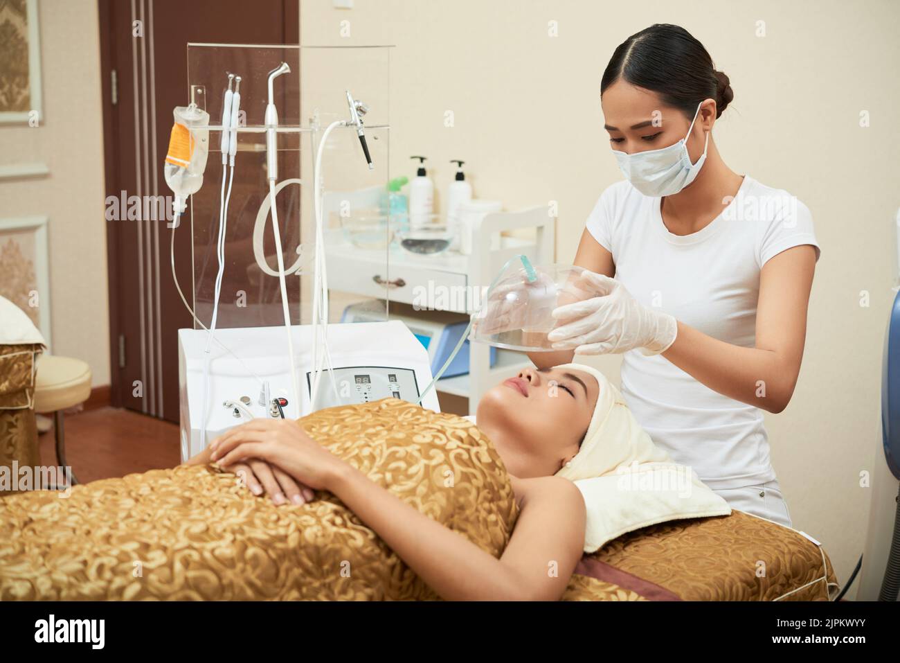 Portrait shot of highly professional Asian cosmetologist using modern ...