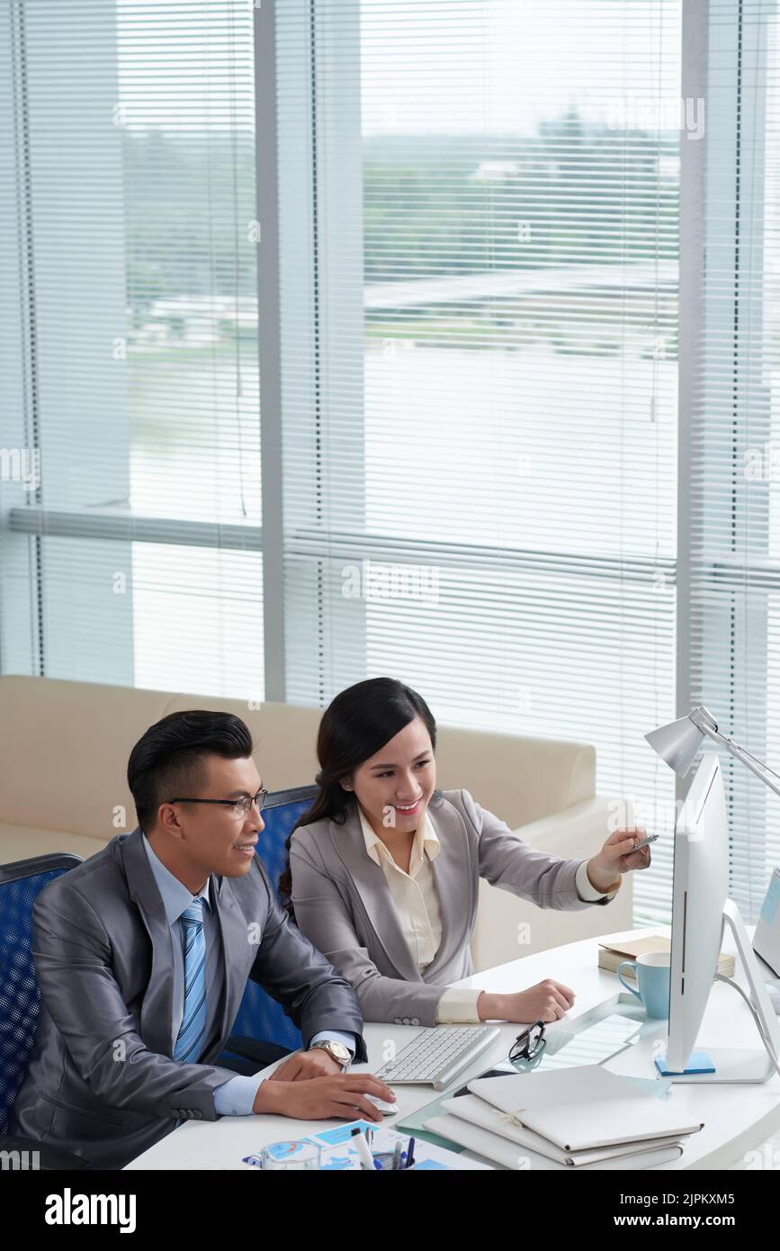 Team of Vietnamese business executives discussing information on ...