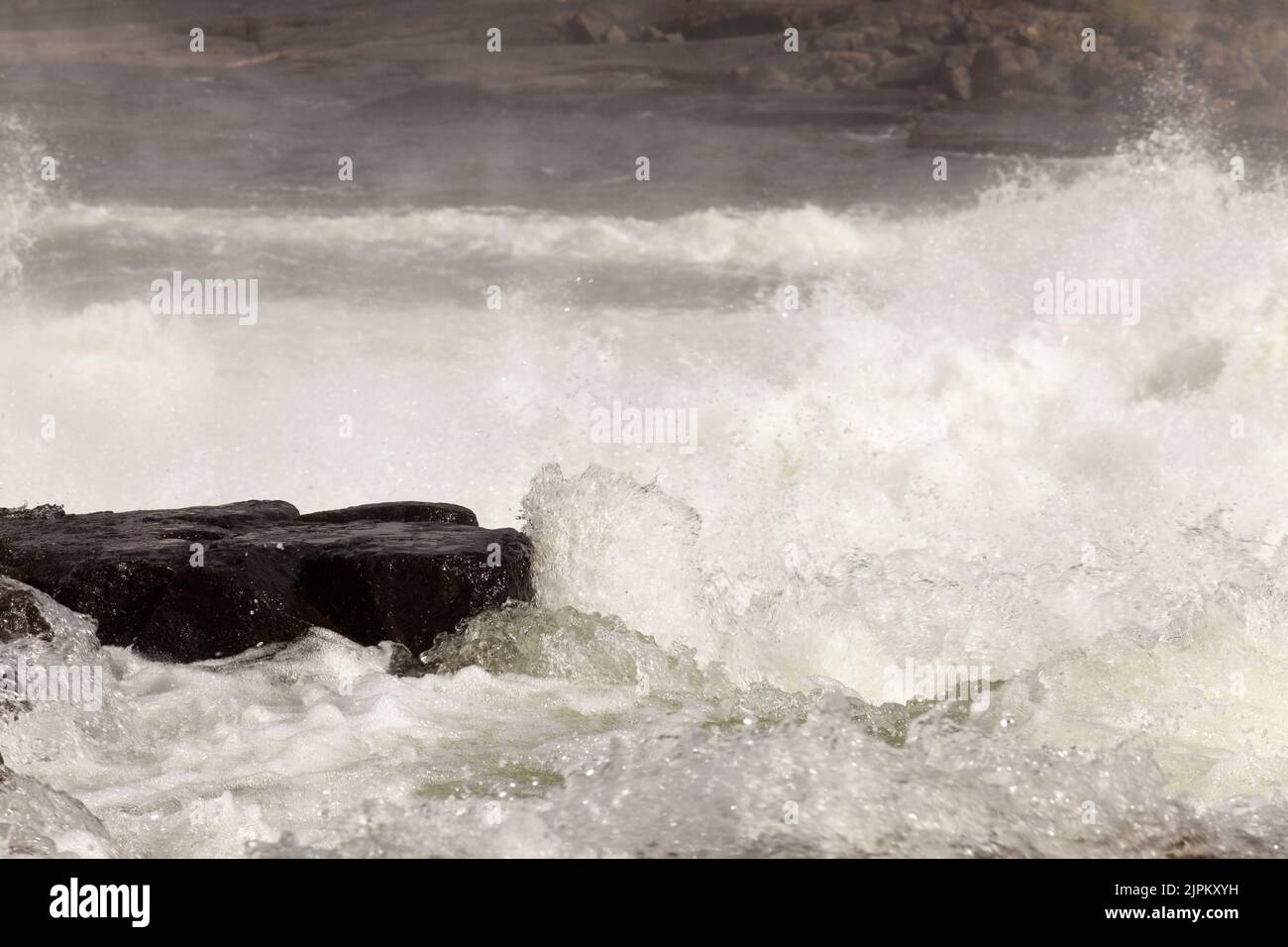 The Cascades of water in the big river. Powerful stream down the valley ...