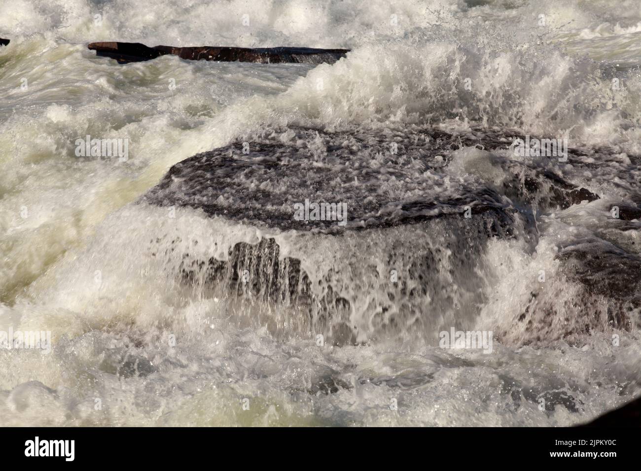 The Cascades of water in the big river. Powerful stream down the valley ...