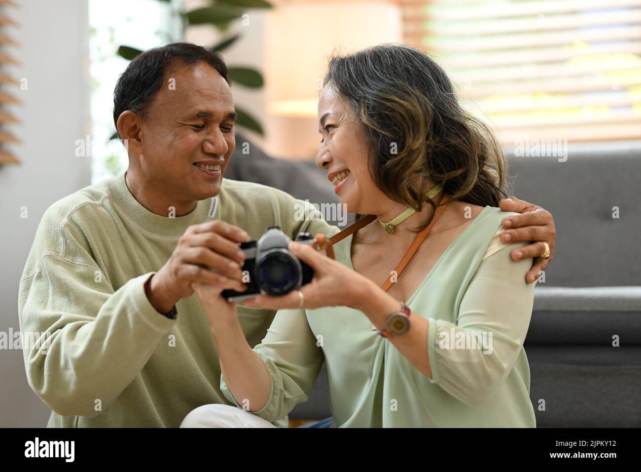 Shot of happy retired couple packing cloth and stuff, getting ready for ...