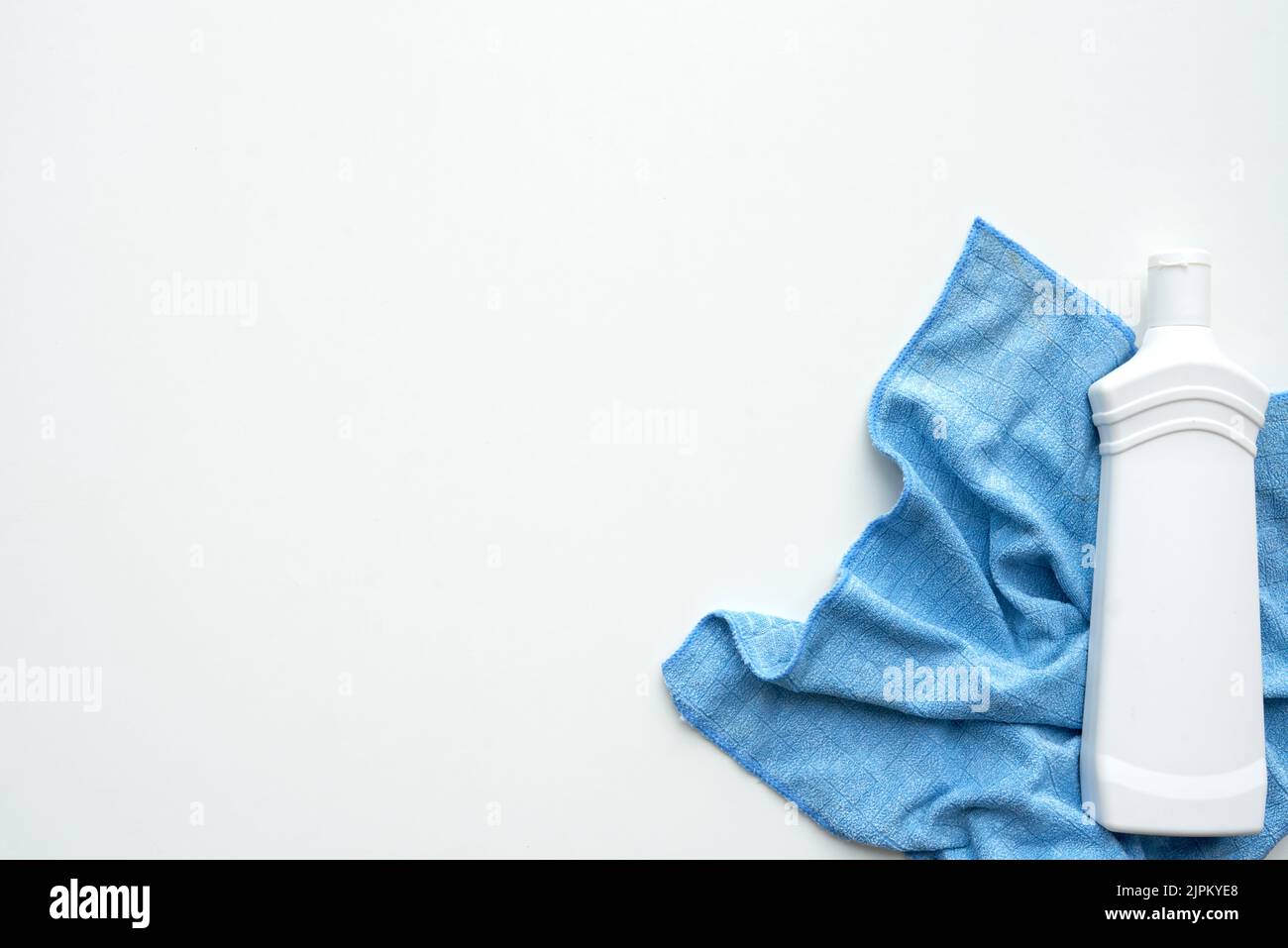 Cleaning cloth and detergent on white background Stock Photo - Alamy