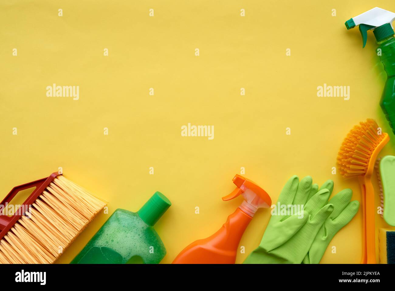Yellow cleaning background with detergents and brushes Stock Photo - Alamy