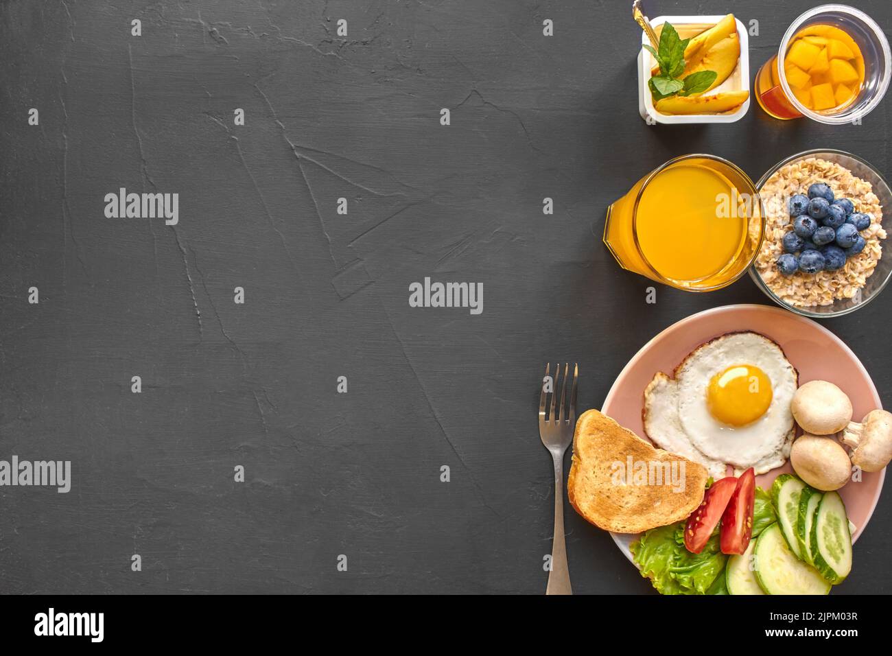 Top view of healthy and delicious breakfast on a black background with ...