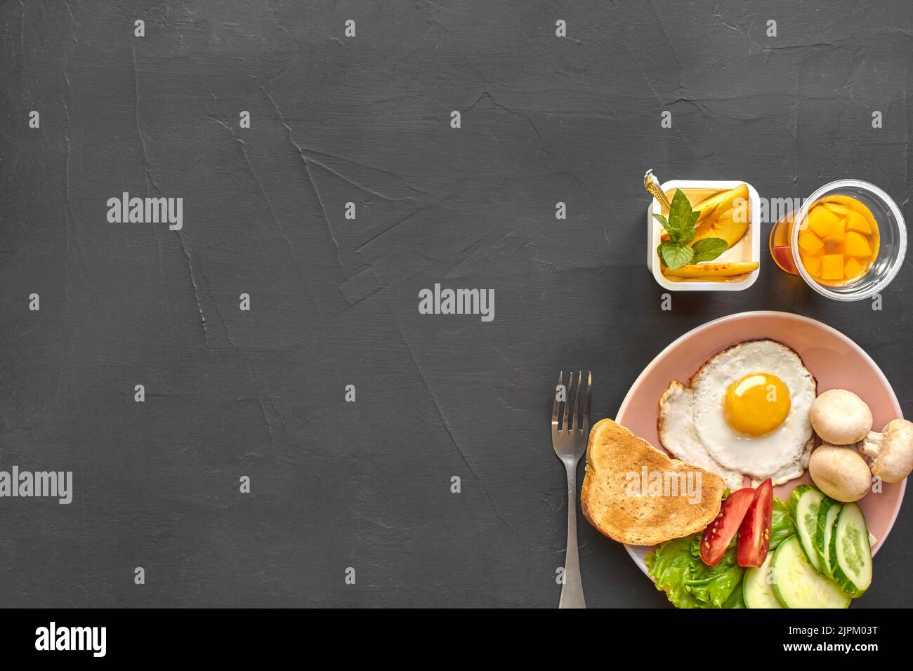 Top view of healthy and delicious breakfast on a black background with ...