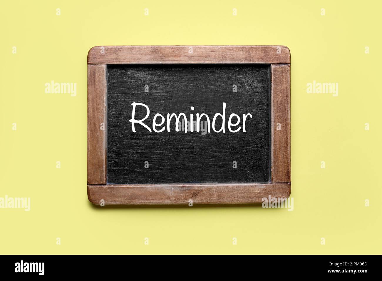 Chalkboard with word REMINDER on yellow background Stock Photo - Alamy