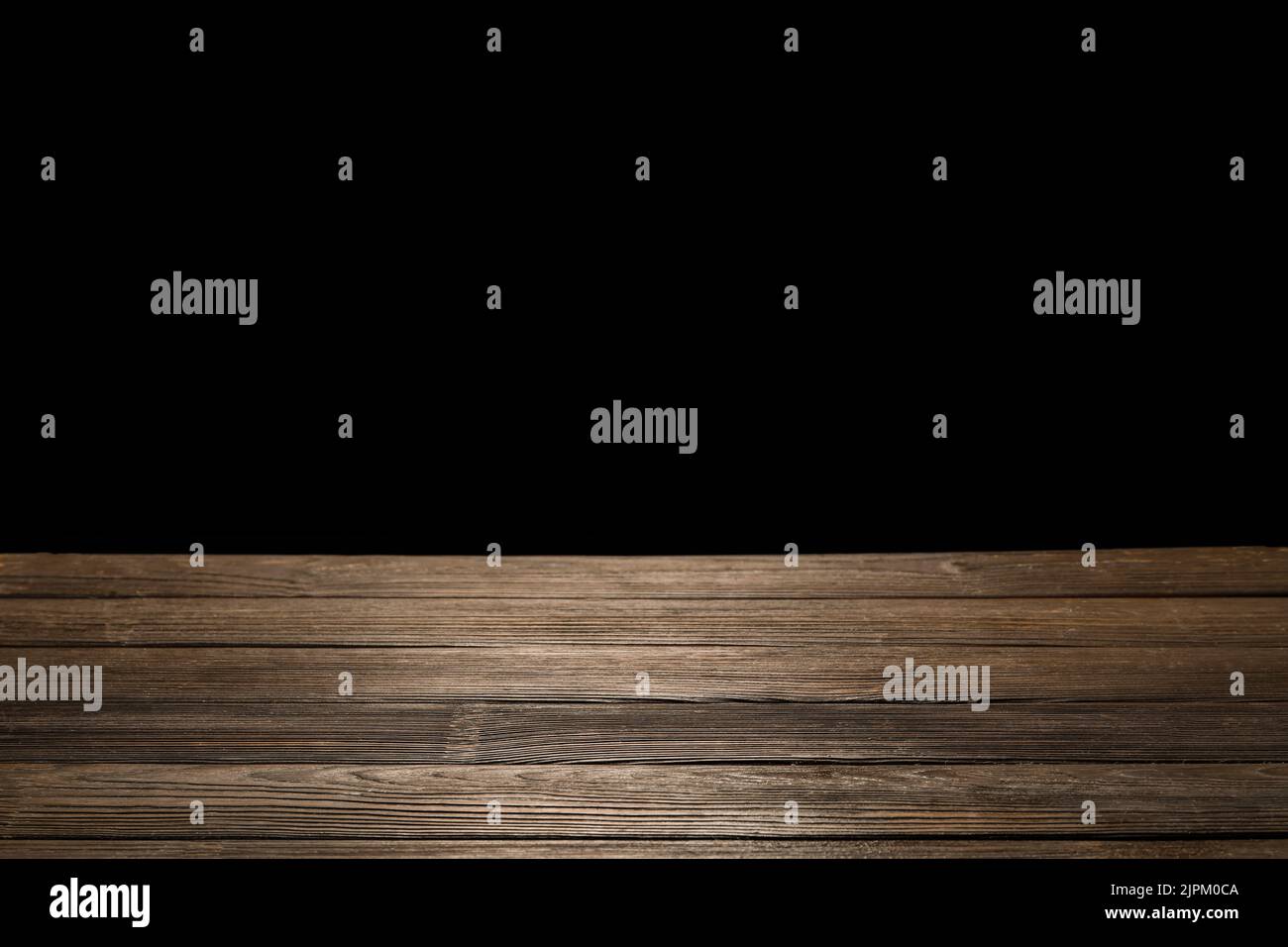 Wooden table top on black background Stock Photo - Alamy