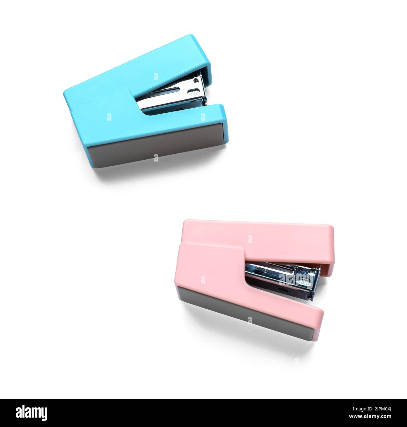 Two colorful staplers on white background Stock Photo - Alamy