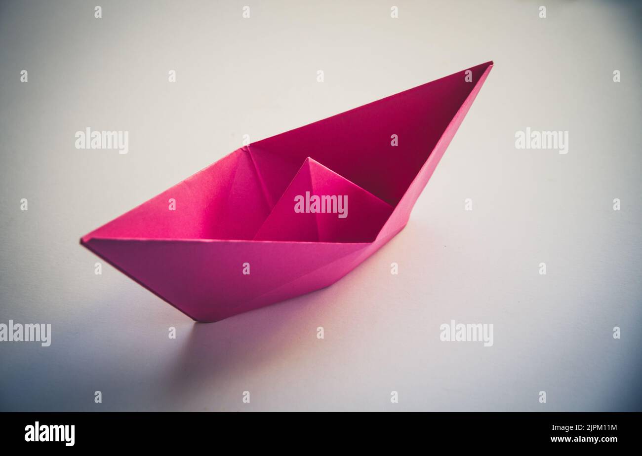 Pink paper boat origami isolated on a blank white background Stock ...