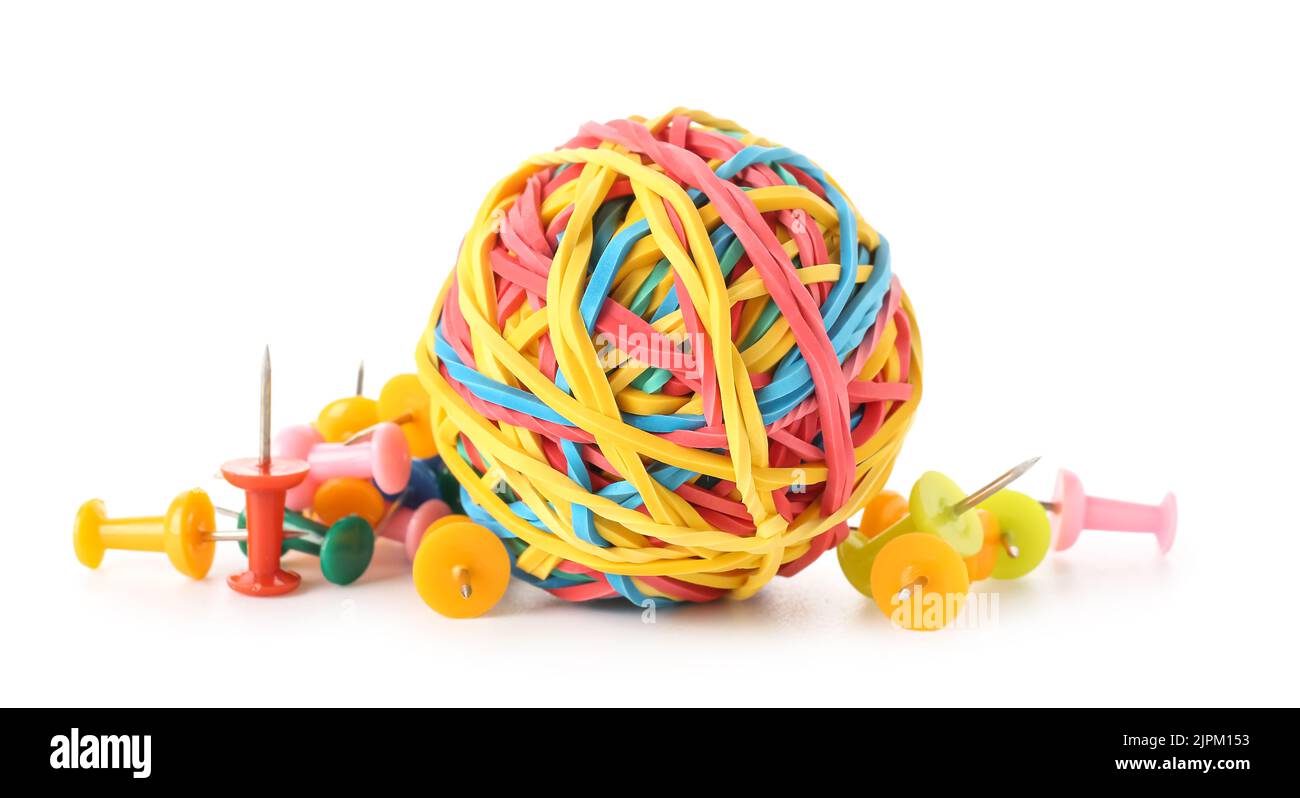 Colorful rubber band ball and paper pins on white background Stock ...