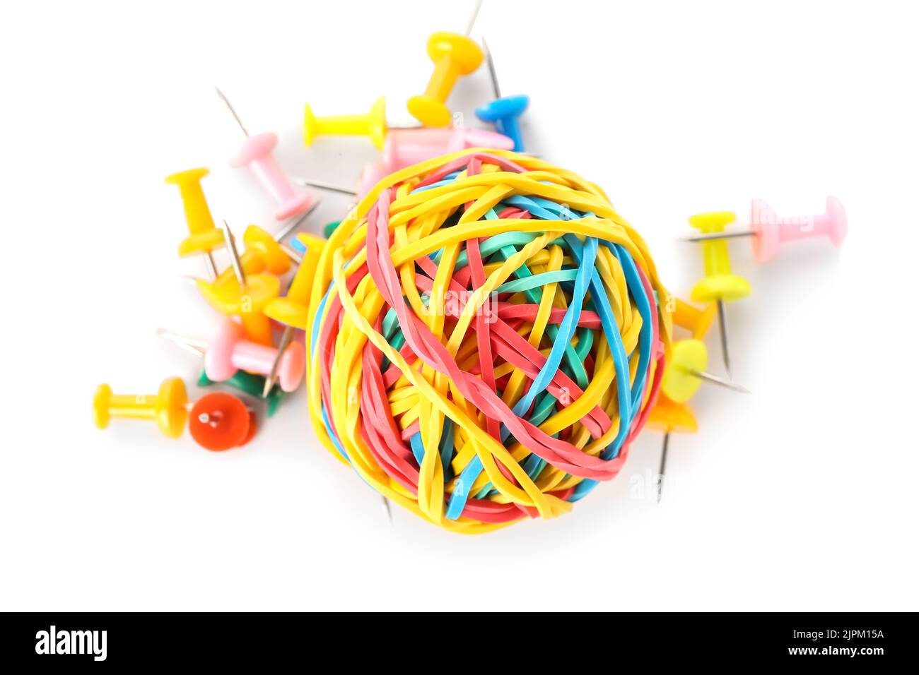 Colorful rubber band ball and paper pins on white background Stock ...